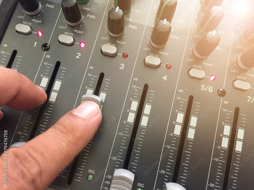 The male hand makes the sound adjustment on the audio mixer Stock Photo ...