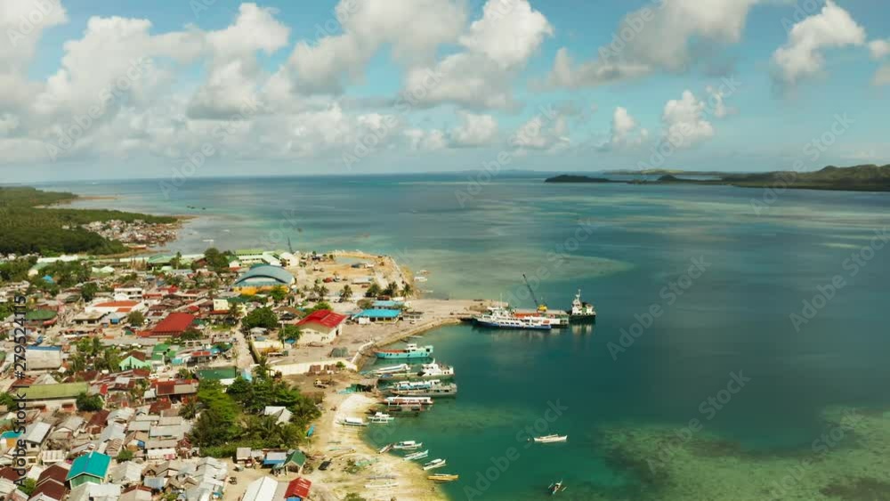 Passenger port with ferries and cargo ships on the island of Siargao ...