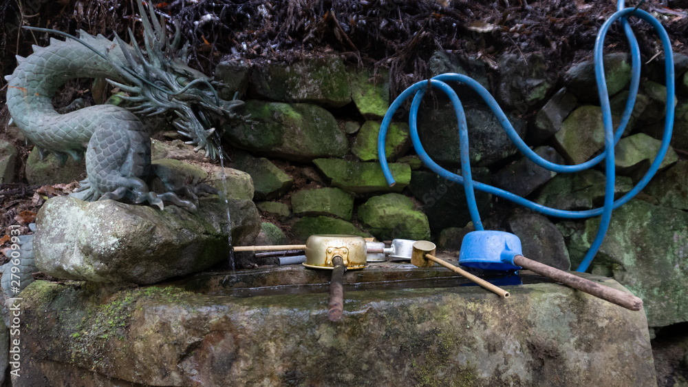 Water dippers with a dragon and blue hose on the trail of Kumano Kodo ...