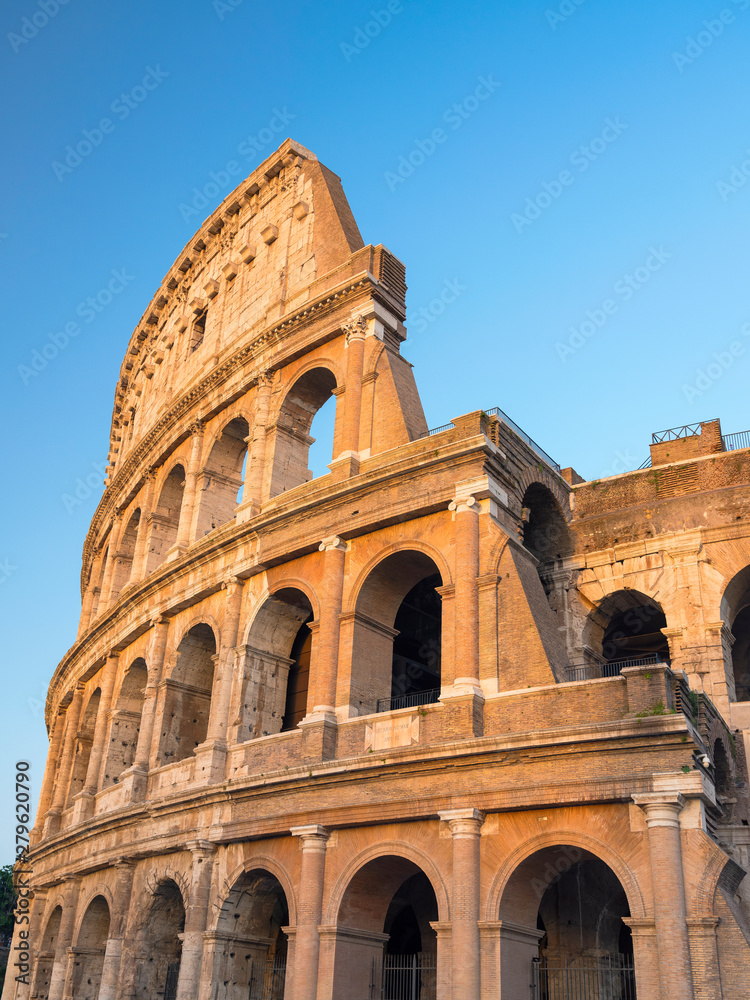 Vertical view to wall with arch of colosseum with blue sky in Rome in ...