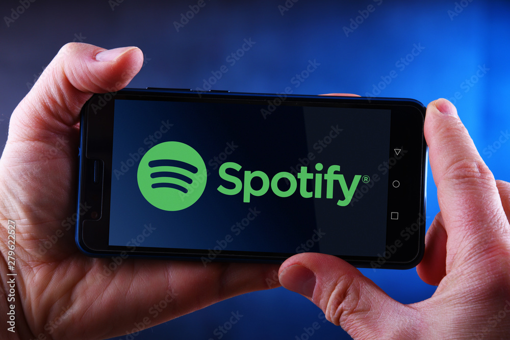 Hands holding smartphone displaying logo of Spotify Stock Photo | Adobe ...