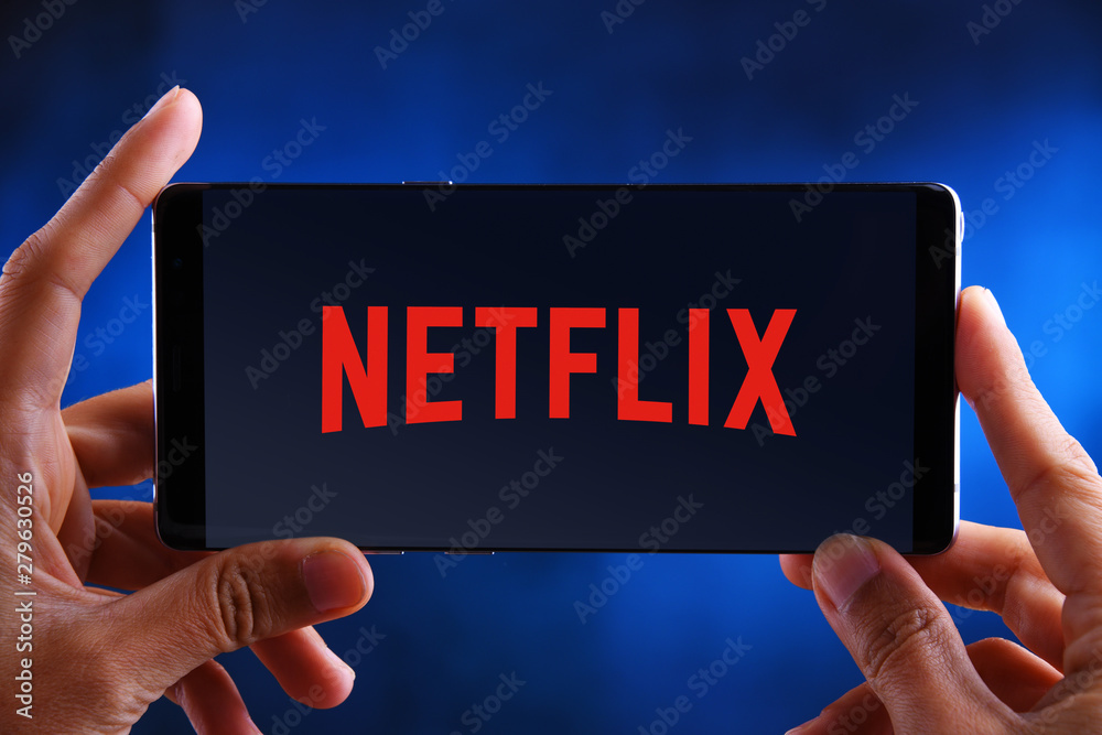 Hands holding smartphone displaying logo of Netflix Stock Photo | Adobe ...