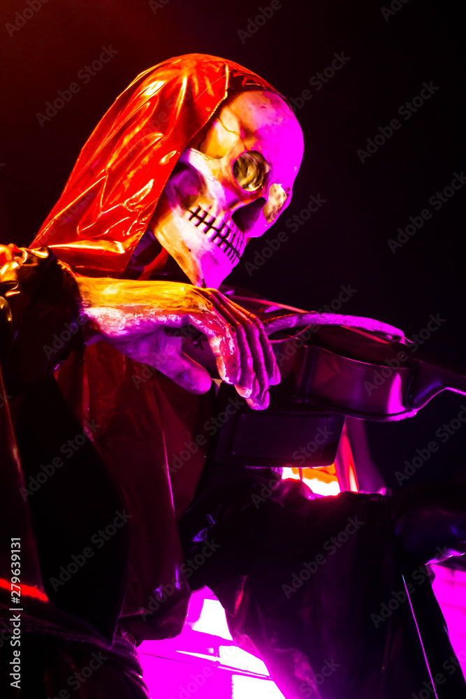 Skeleton play on violin. A terrifying sculpture in a amusement park ...