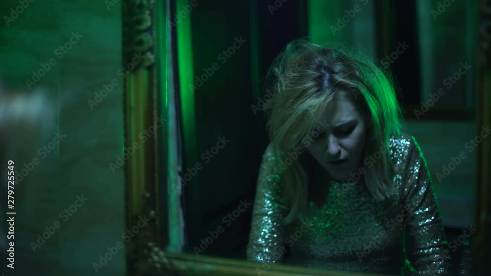 Drunk woman looking in mirror, vomiting after night club party ...