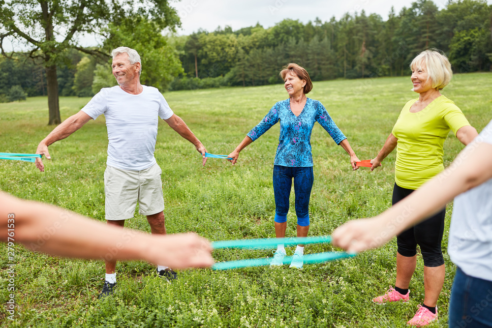 Senior group with stretch band in rehab Stock Photo | Adobe Stock