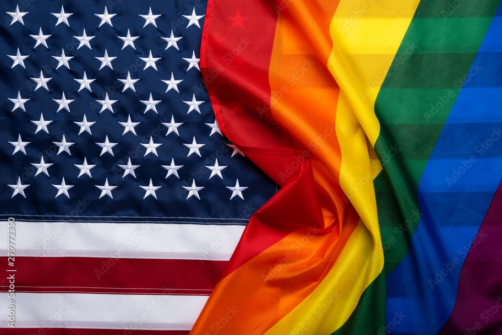 Pride rainbow lgbt gay flag over American US flag . Equality diversity ...