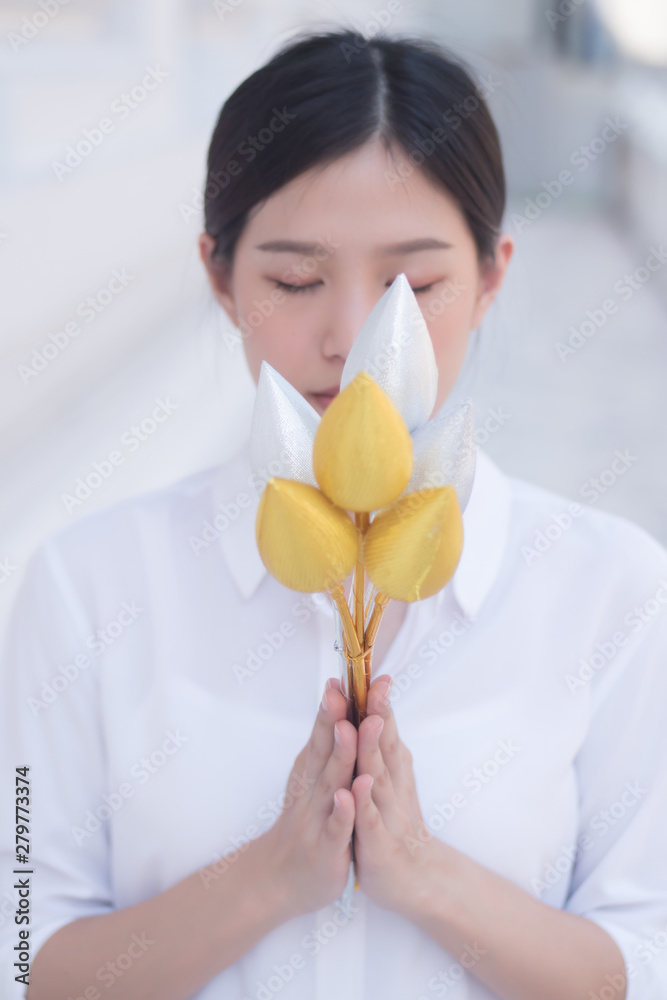Pious, religious Asian buddhist woman praying, chanting mantra to the ...