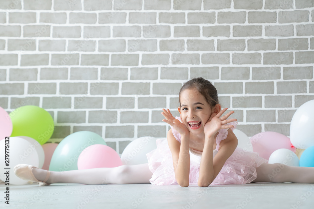 Cute little young girl ballerina dancer in pink leotard and tutu are ...