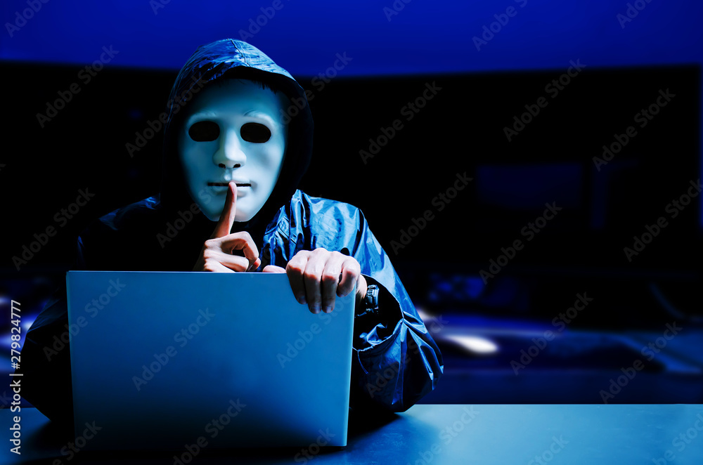 Foto de Anonymous computer hacker in white mask and hoodie. Obscured ...