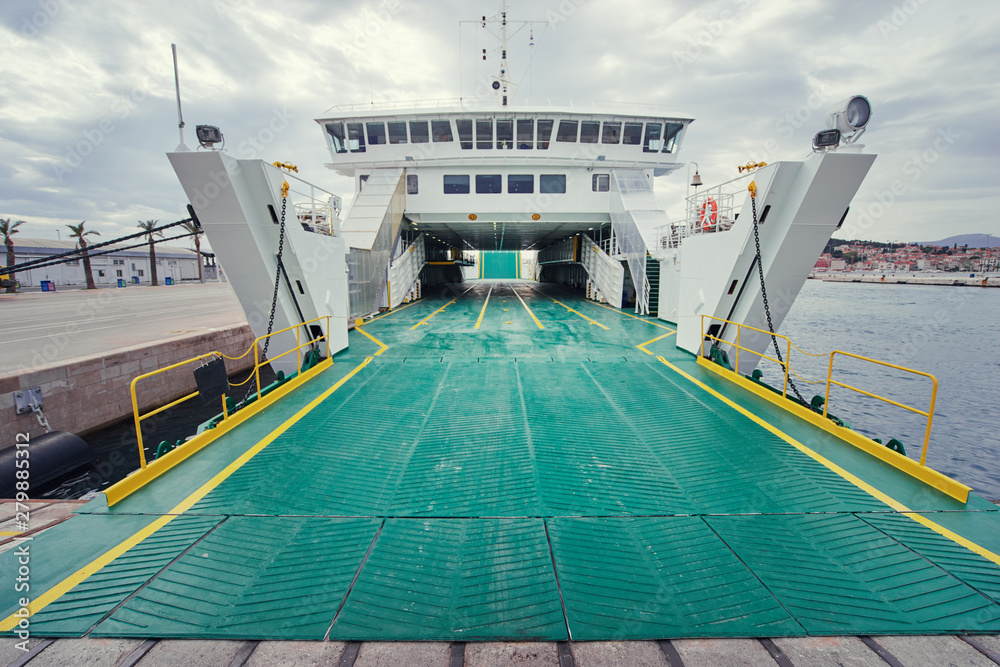 Ferryboat loading or unloading by a port pier. Concept of ...