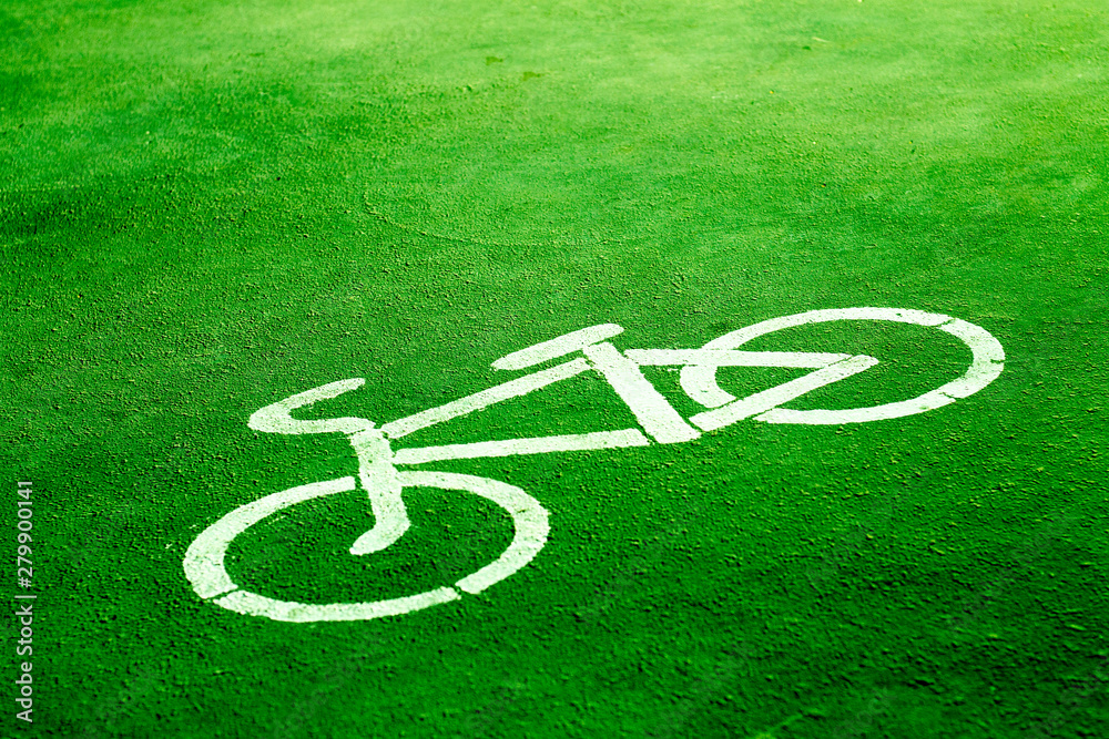 bicycle sign stencilled with white paint on a bright green pavement ...