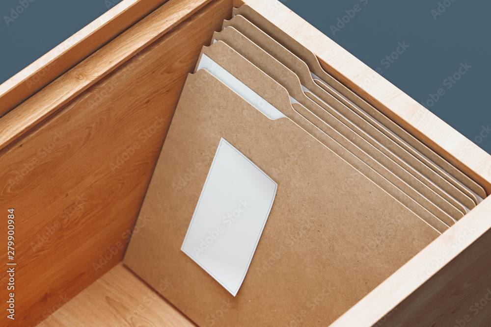Cardboard folders with documents and white paper sheets in wooden box ...