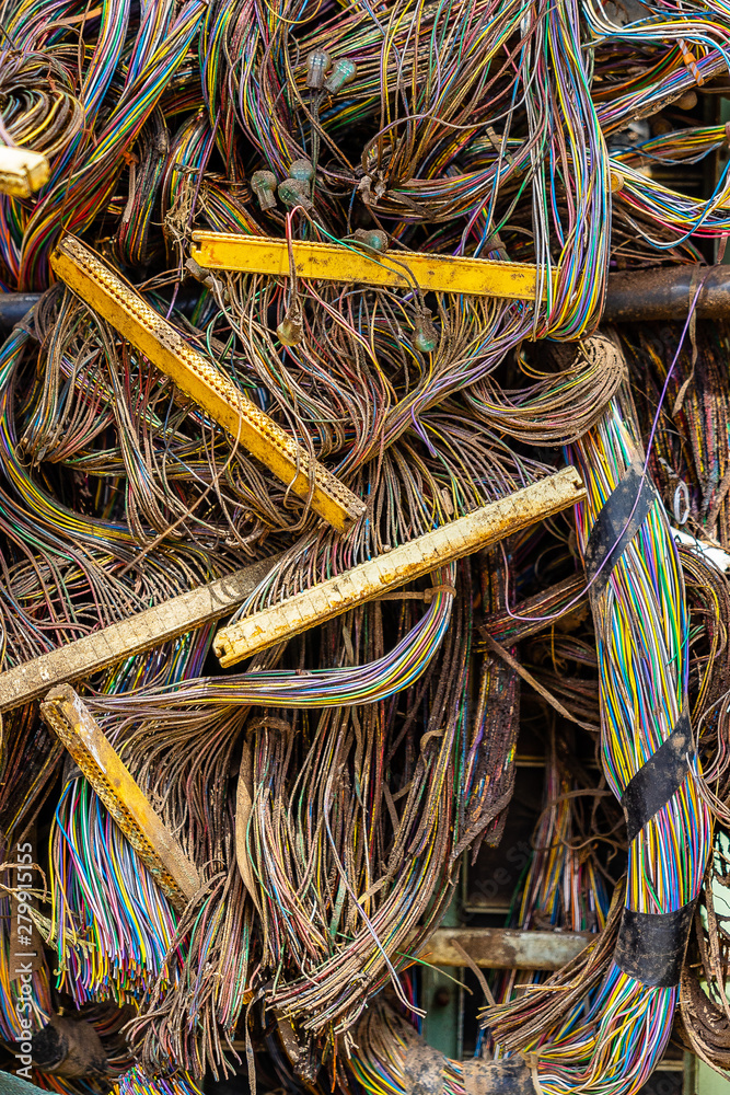 Bundles of multicolored wires intertwined with each other in the rack ...