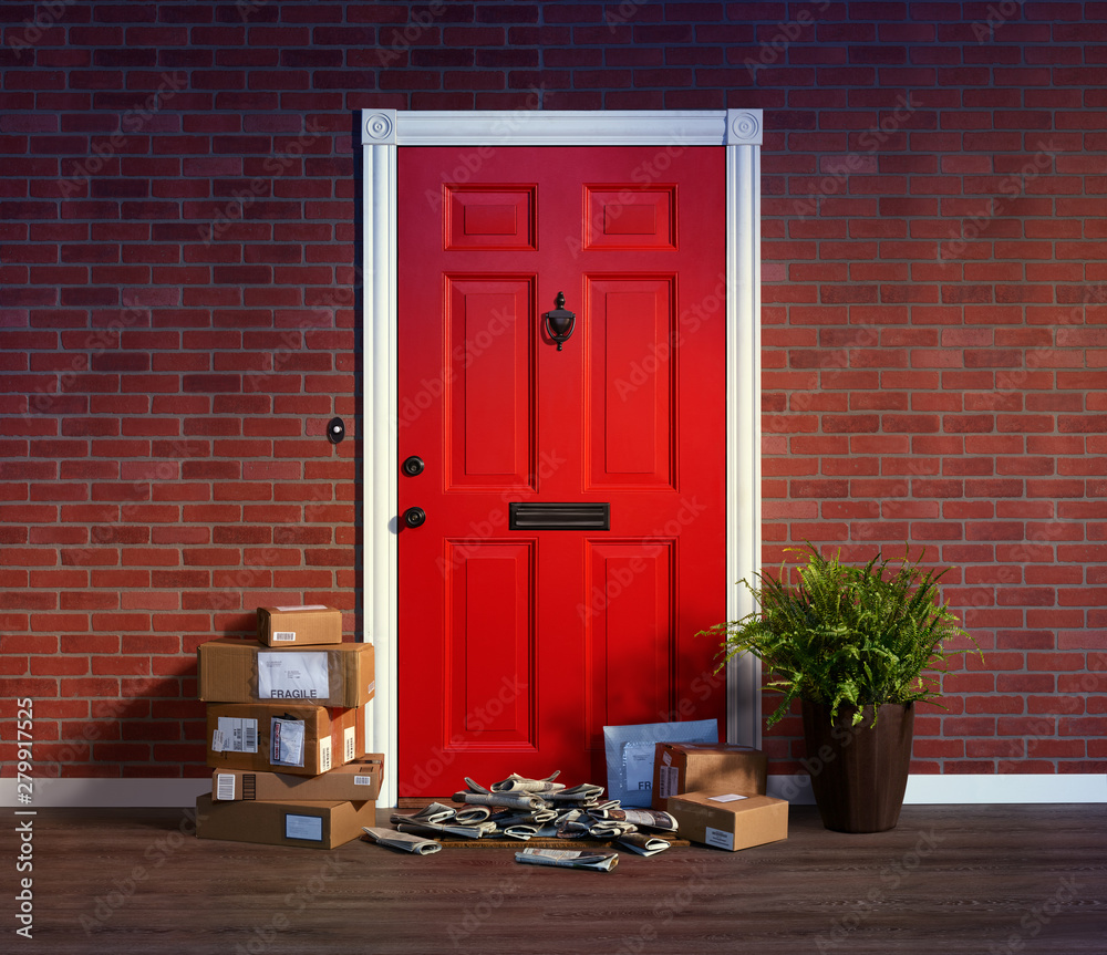 Residential front door with stacks of delivered boxes and newspapers ...