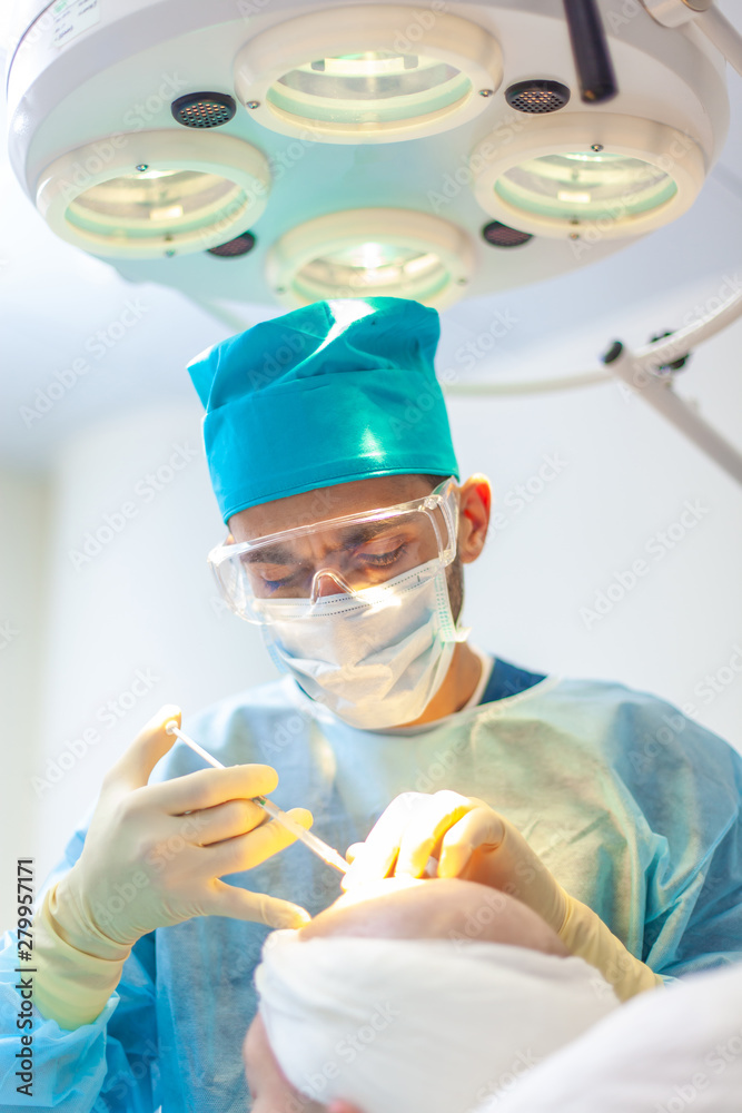 The surgeon gives injections to the head. Baldness treatment. Hair ...