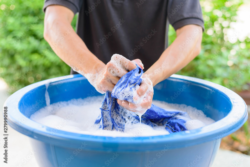 hand washing clothes in Blue basin Stock Photo | Adobe Stock