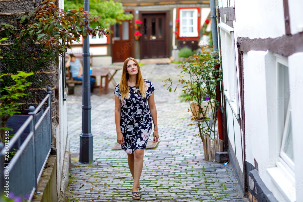 Beautiful young woman with long hairs in summer dress going for a walk ...