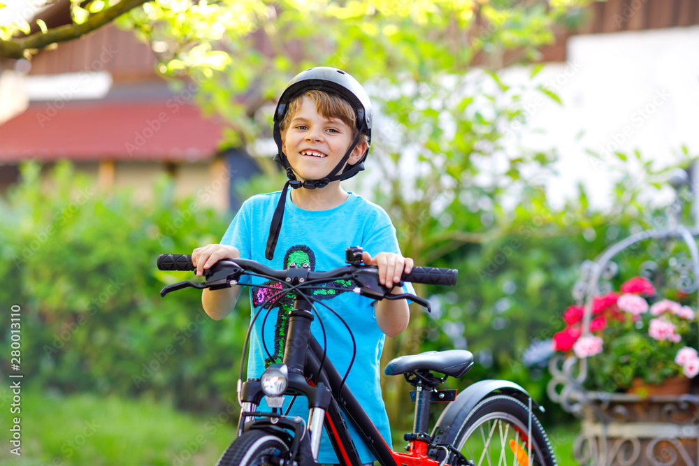 Happy school kid boy having fun with riding of bicycle. Active healthy ...