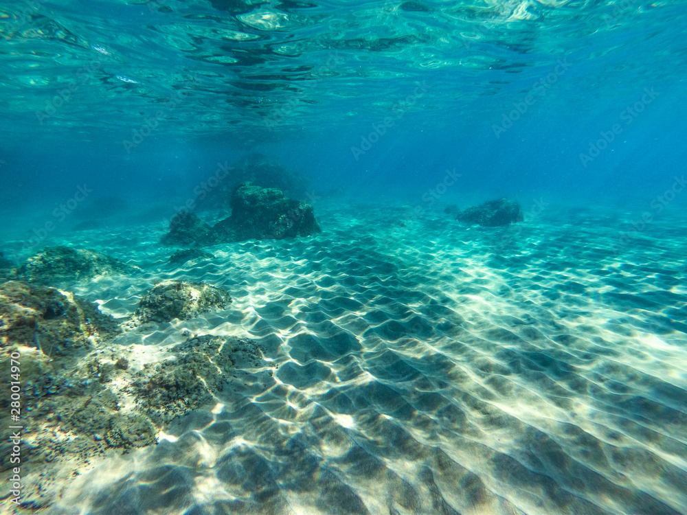 Underwater view of the rocks, sand and stones. The sandy and rocky ...