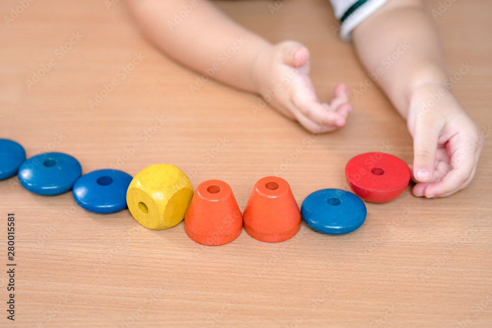 An adorable preschool kid's hands (2-3 years) in Montessori classroom ...
