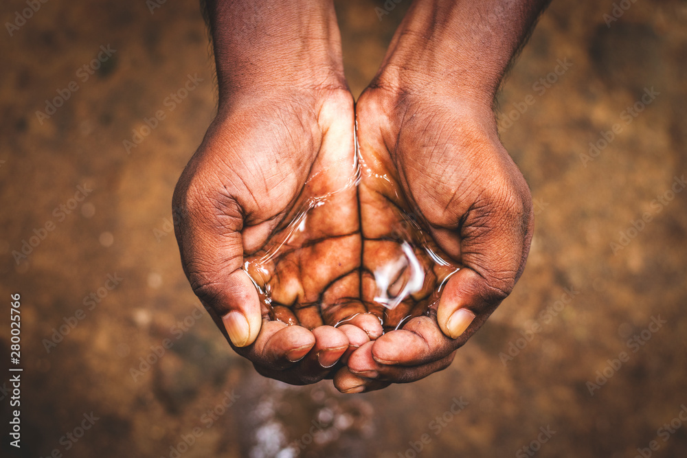 a man holding water with his hand,water crisis in India and worldwide ...