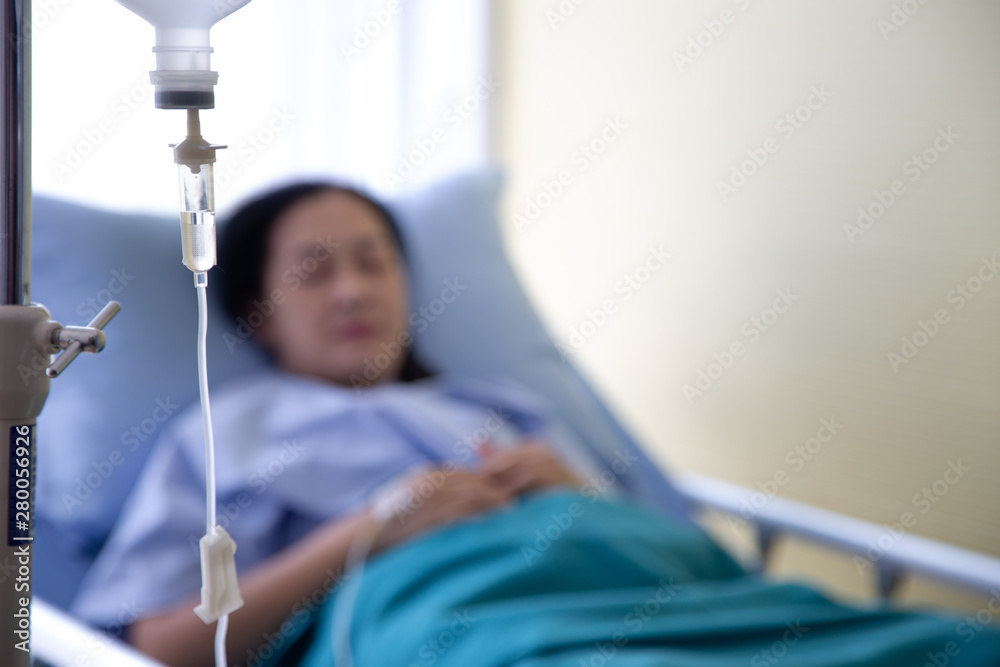 Focus intravenous drop saline drip in hospital and blurry background ...