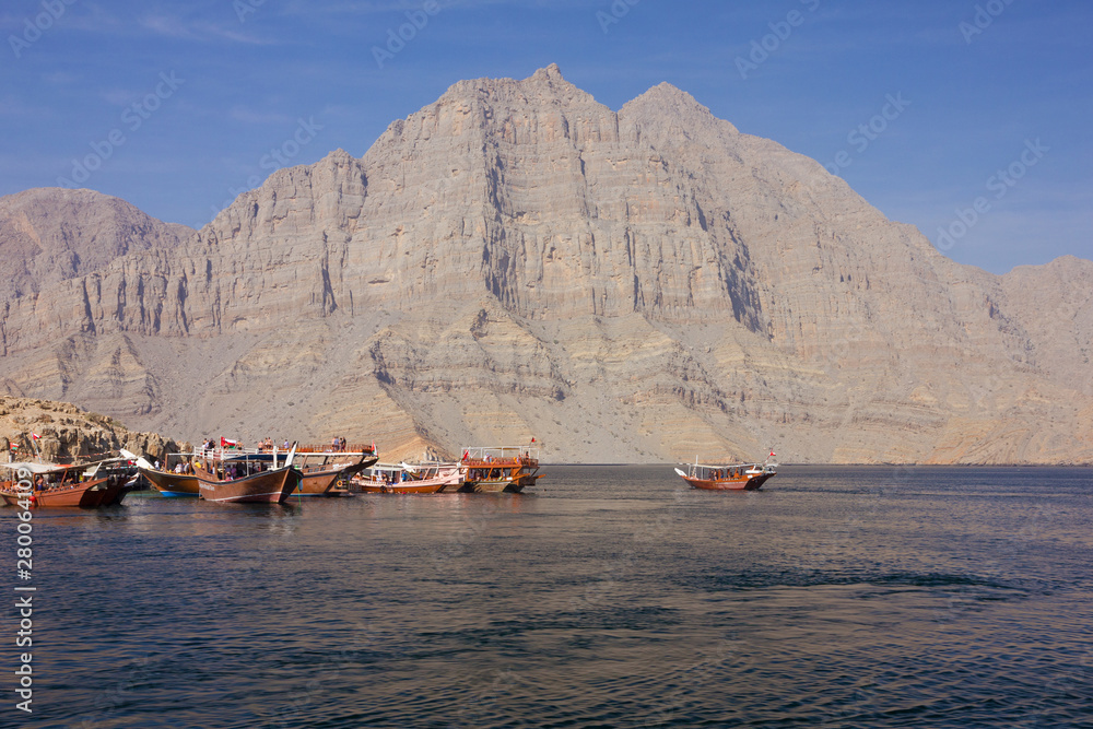 Oman fjords mountain sea view, tourist dhow boats, Khasab, Musandam ...