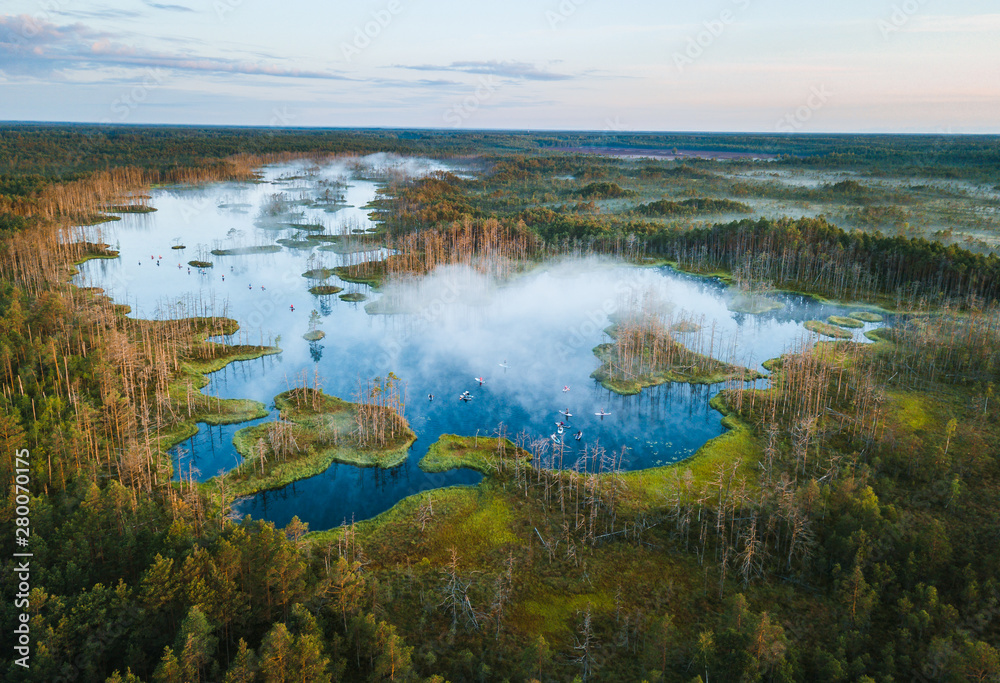 Warmly colored sunrise over a foggy swamp. Aerial view of stunning ...