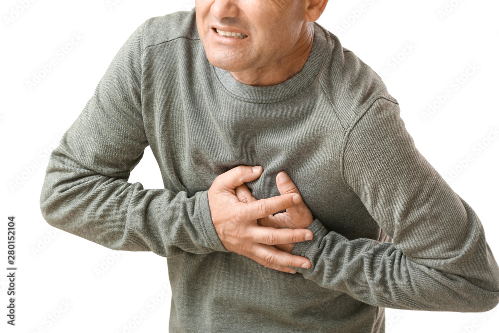 Mature man suffering from heart attack on white background Stock Photo ...