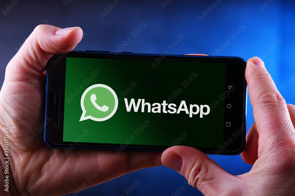 Hands holding smartphone displaying logo of WhatsApp Messenger Stock ...