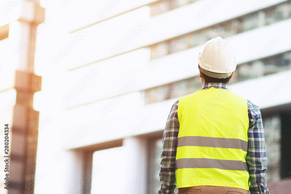 back view of engineering man construction worker wear safety helmet and ...
