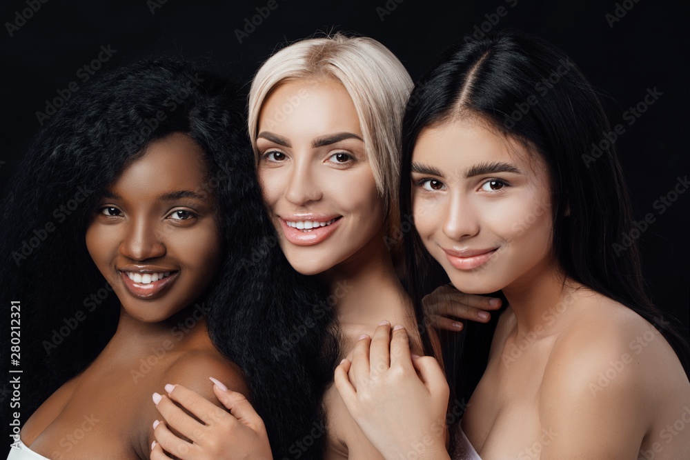 Beauty portrait of three multiracial women posing in studio. Sensual ...