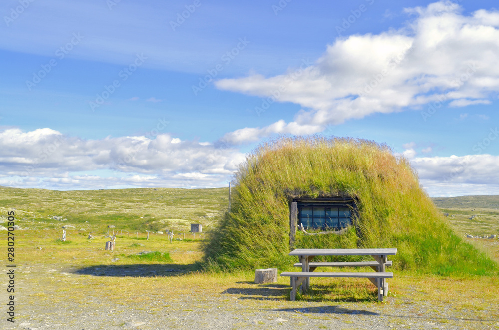 Traditional Norwegian wooden house with lawn around in Hardangervidda ...