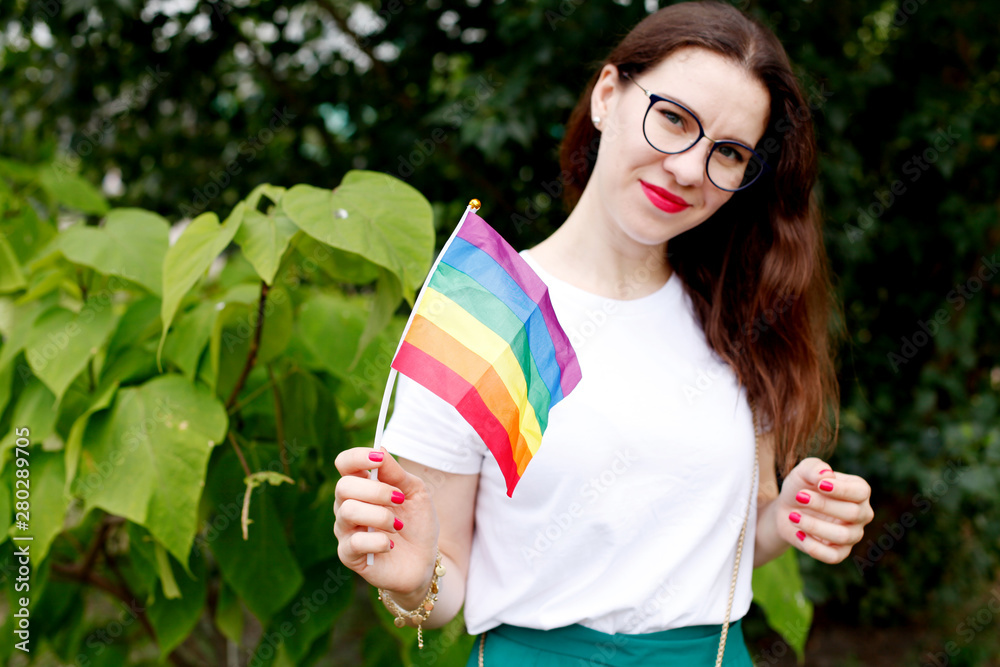 The concept of LGBT rights, the hand holds the LGBT flag, against the ...