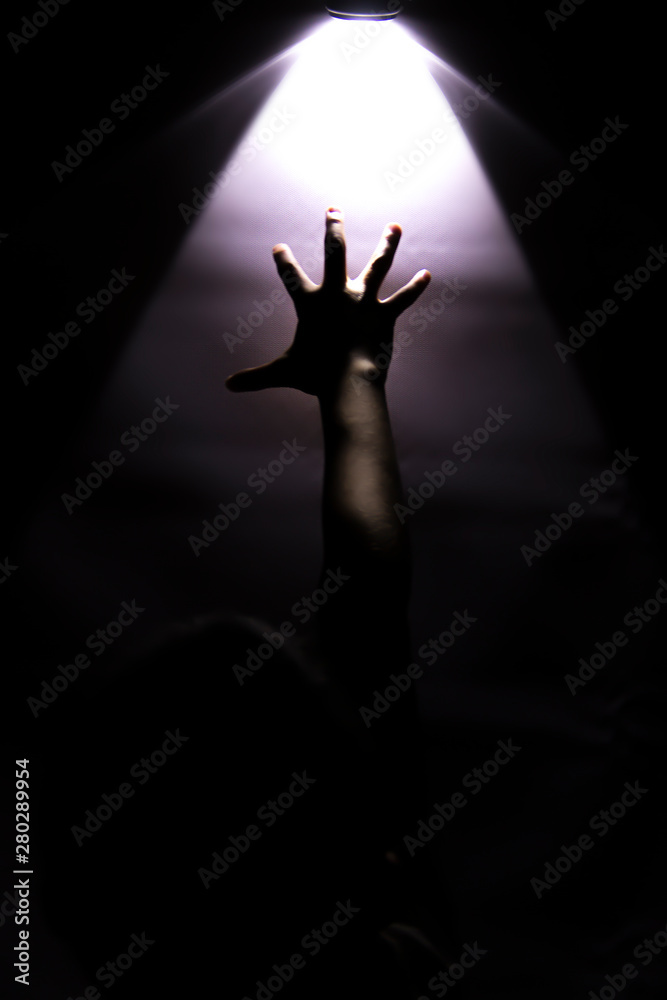 hand reaching up to touch a glowing light Stock Photo | Adobe Stock