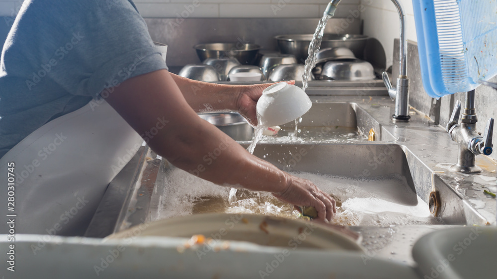 Woman washing dishes Stock Photo | Adobe Stock