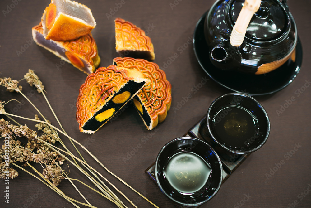 Beautiful Moon cakes and teacup on wooden table. Mid autumn festival ...