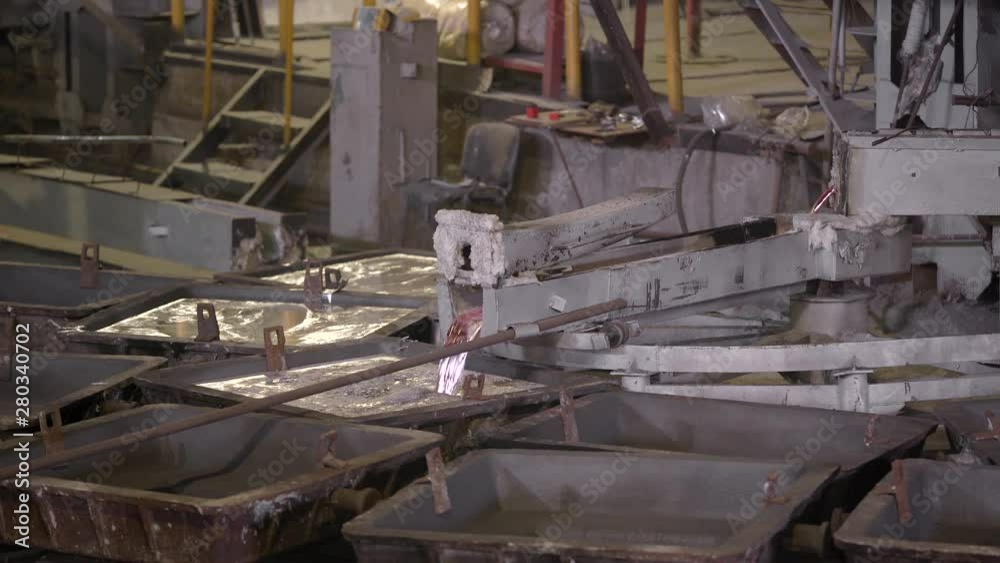 Close-up, the hot metal is poured from the furnaces special baths ...