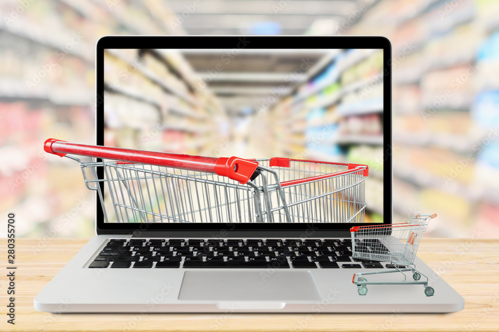 supermarket aisle blurred background with laptop computer and shopping ...