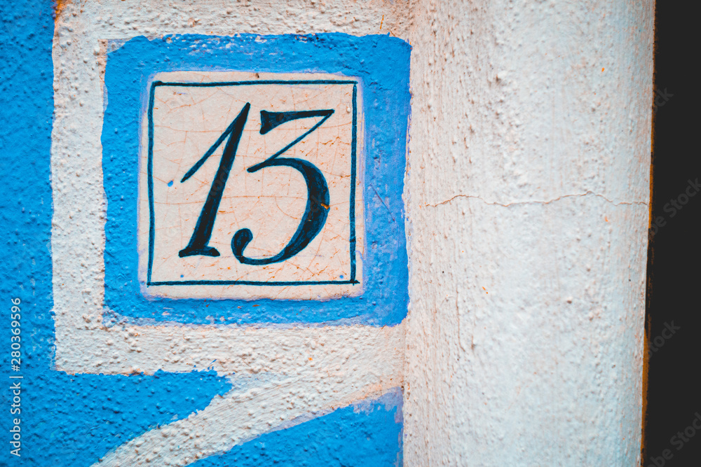 number 13 door sign on blue and white facade Stock Photo | Adobe Stock