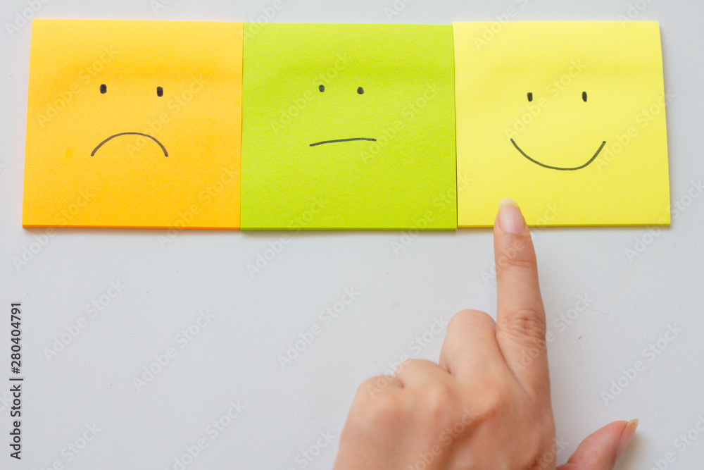 Hand with Sticky note face smile and sad on board ,emotion paper. Stock ...