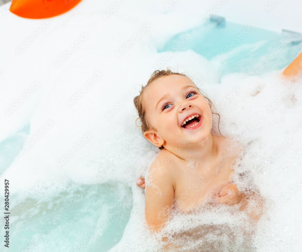 Little girl takes a bath in a hydromassage bathtub. Stock Photo | Adobe ...