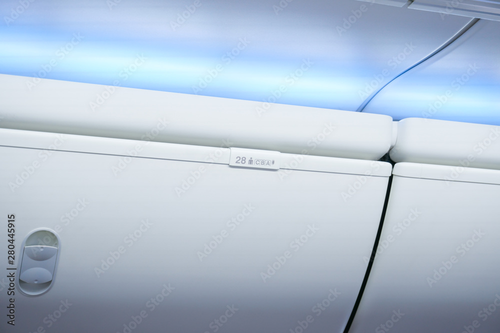 Airplane cabine with luggage compartments,luggage ready for departure ...