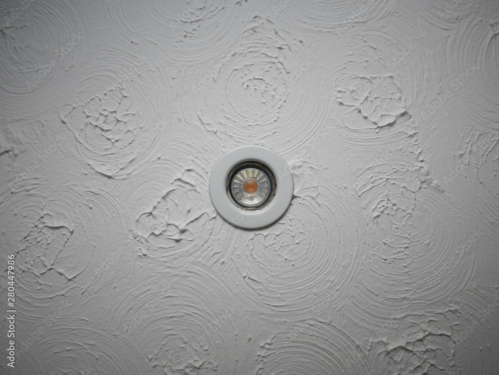 LED downlight in swirly patterned ceiling plaster pattern known as ...