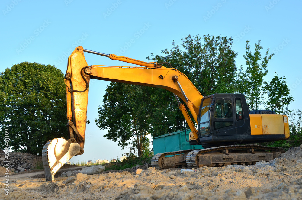 Excavator at a construction site during earthworks and laying of ...