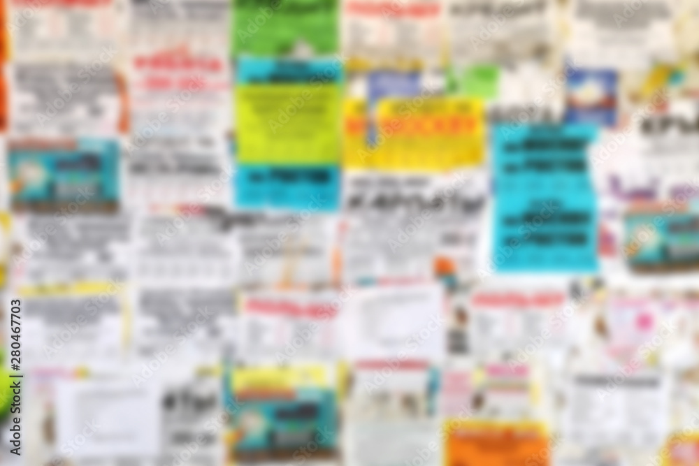 Blurred background of bulletin board outside. Bulletin board filled ...