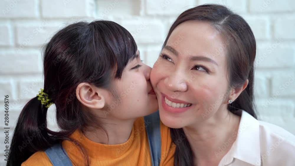Asian Teenage Daughter Kissing Mother Showing Love Between Mother And