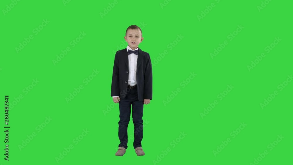 Boy in a suit walks in a frame and starts talking on a Green Screen ...