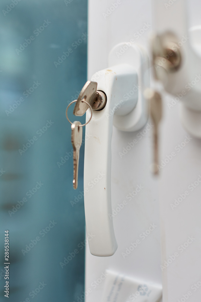 Protecting a child from falling out of windows. Handle with a lock on ...