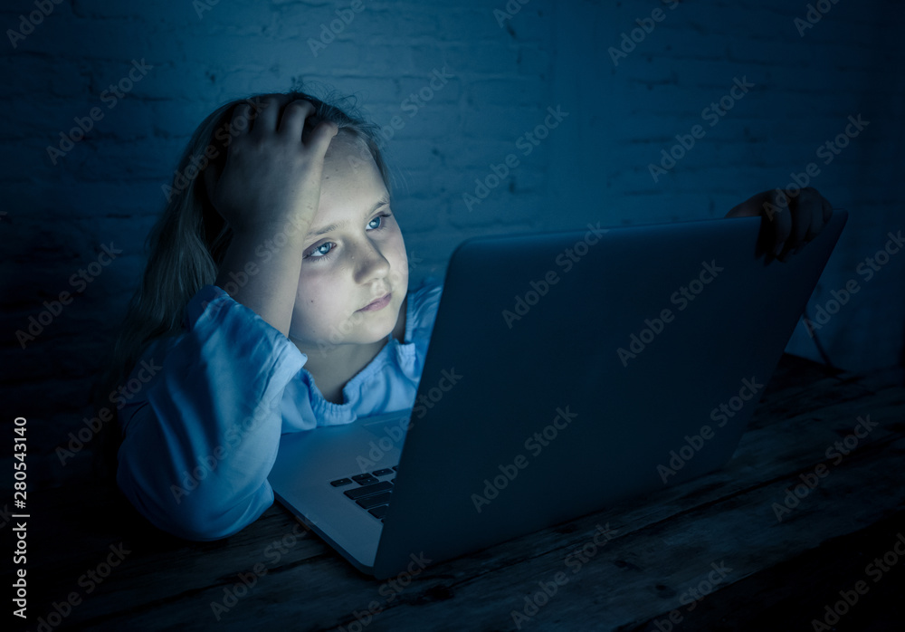 Sad young girl with laptop suffering bullying and harassment online ...